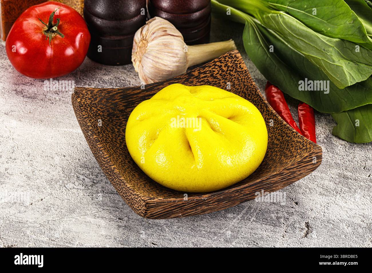 Asian stuffed steamed yellow Bun Bao Stock Photo - Alamy