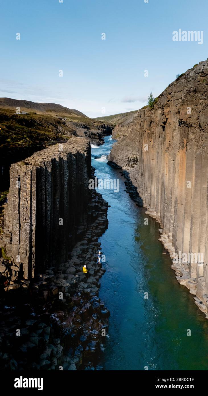 Experience the breathtaking beauty of Studlagil Canyon in Iceland, where unique basalt columns ...