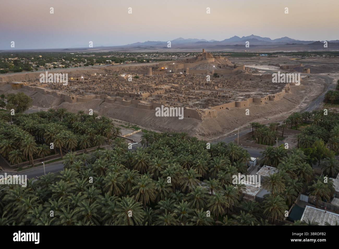 Aerial view of the ancient Arg-e Bam citadel glows with warm light ...