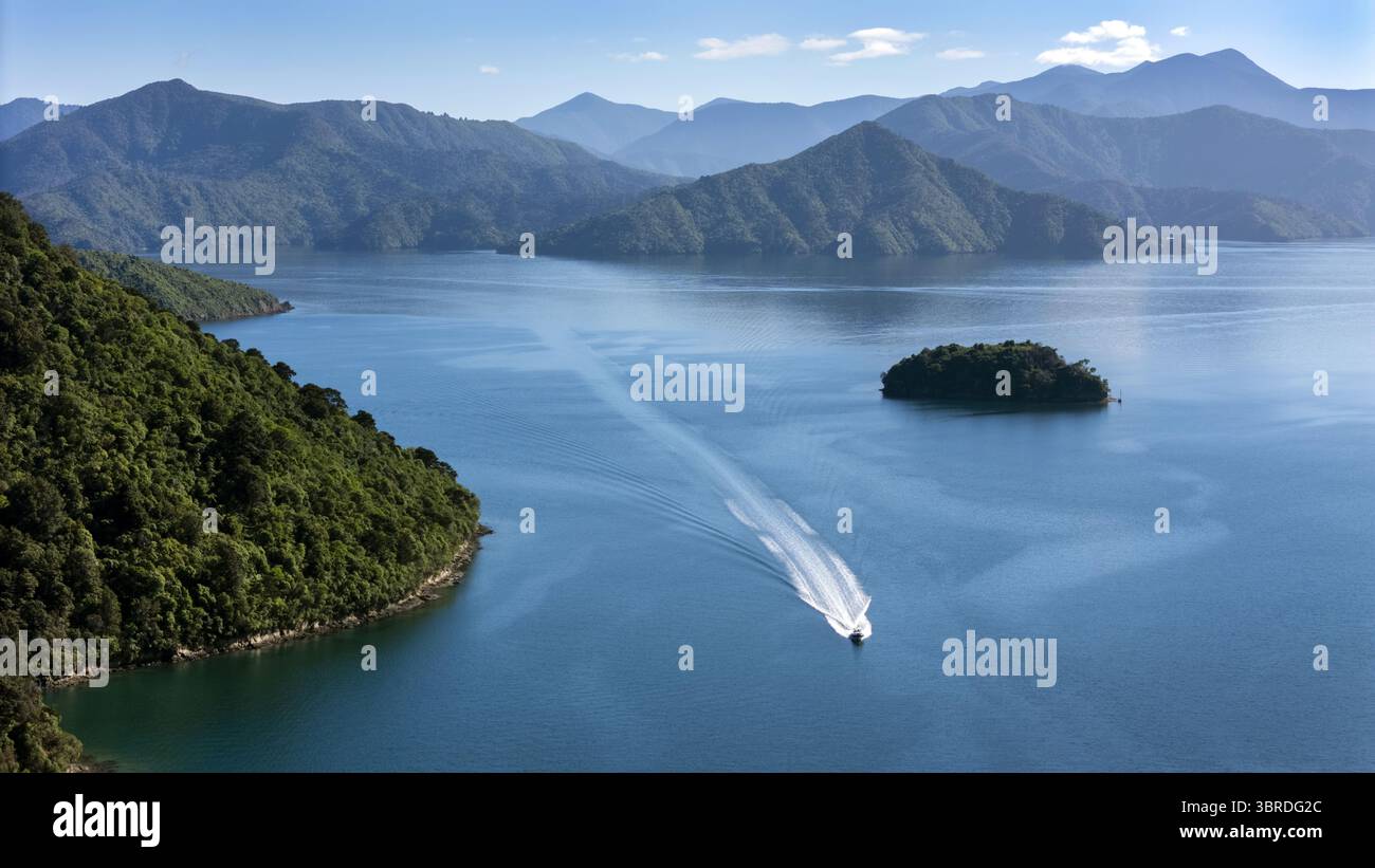 Aerial view of a boat cutting through the tranquil blue waters towards ...