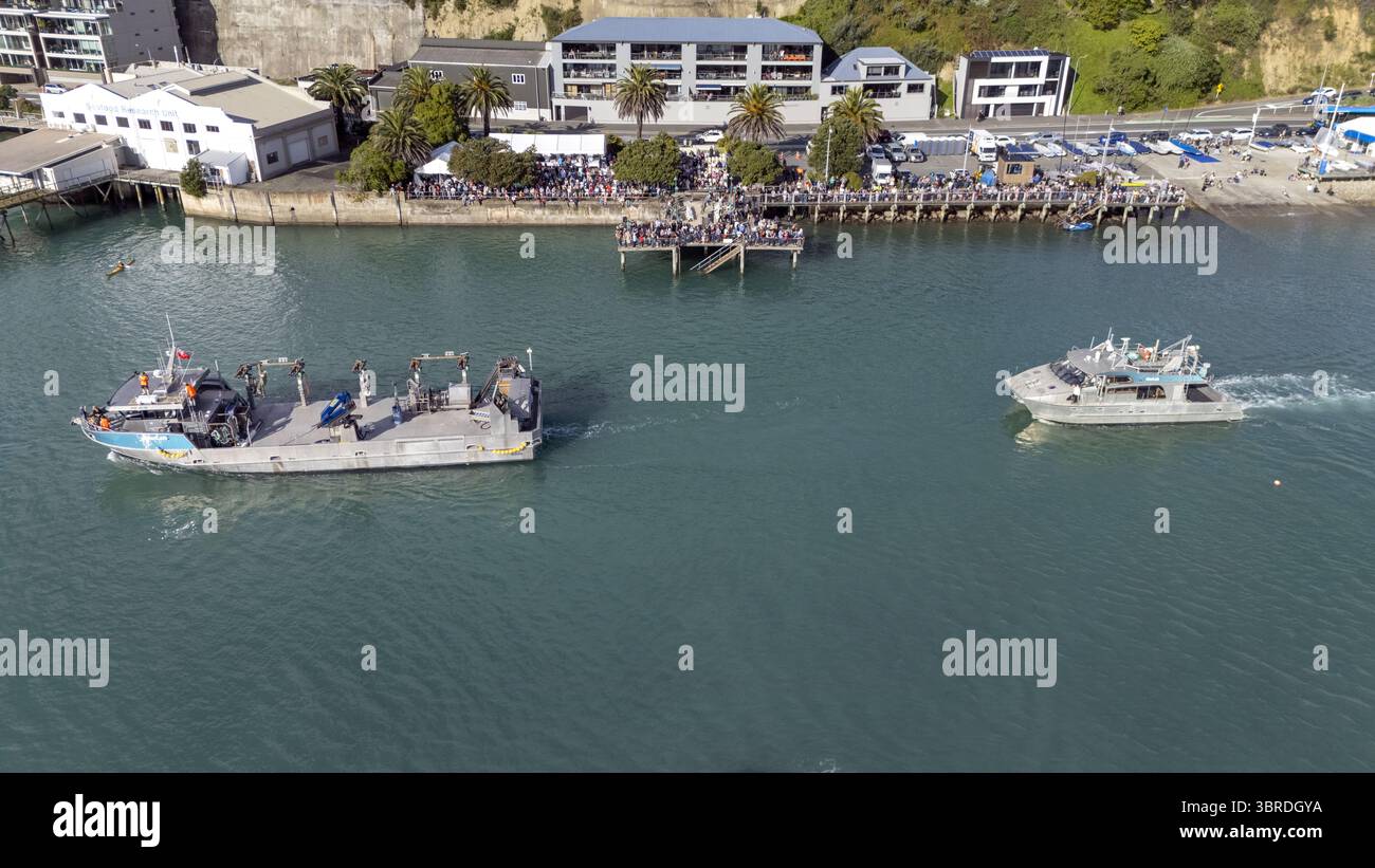 Aerial view of boats navigating crystalline waters near a bustling pier ...