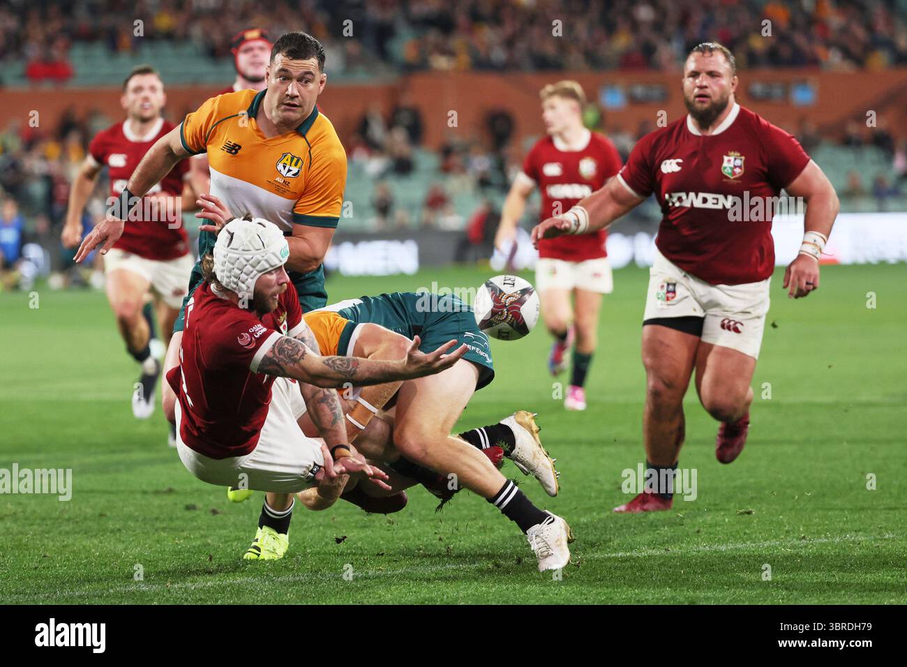 Mack Hansen of the British & Irish Lions passes the ball as he is ...