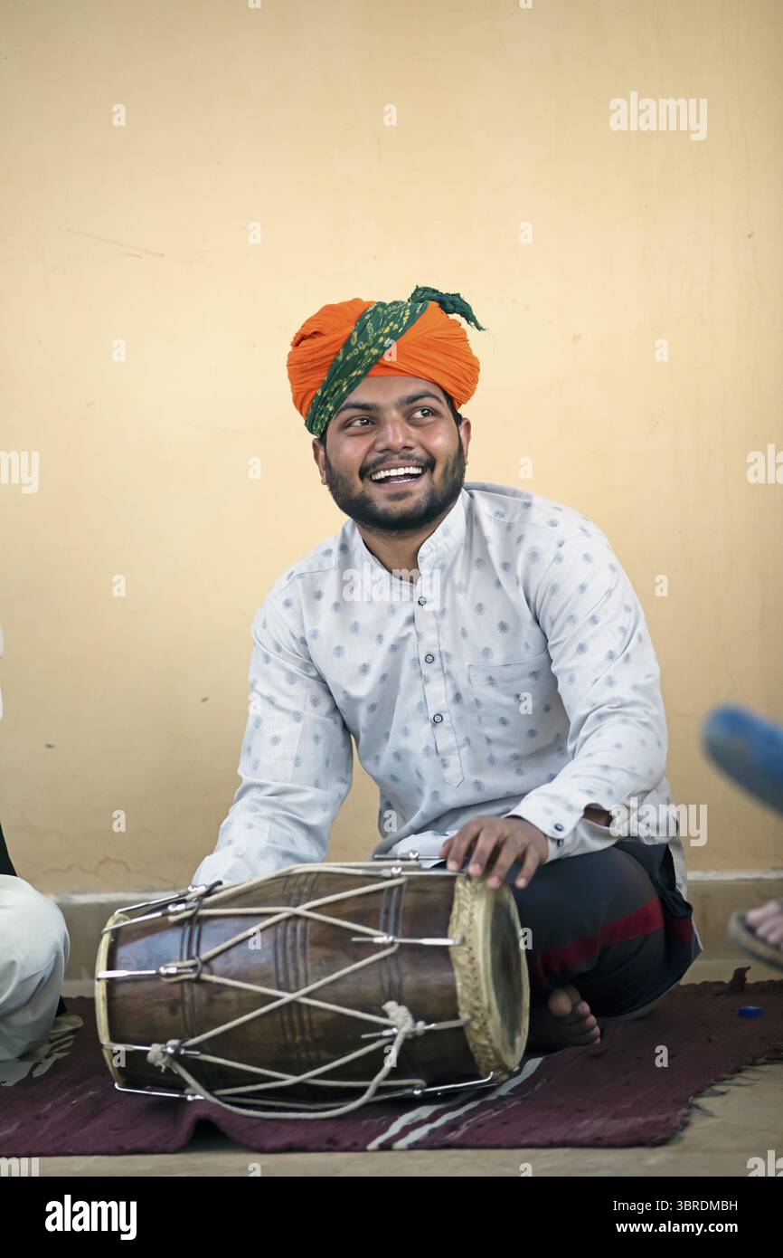 Rajasthani folk musician with a dhol or tubular drum, Jaisalmer ...