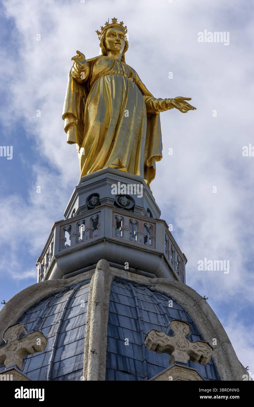 Golden statue of the Virgin Mary on the bell tower of the chapel ...