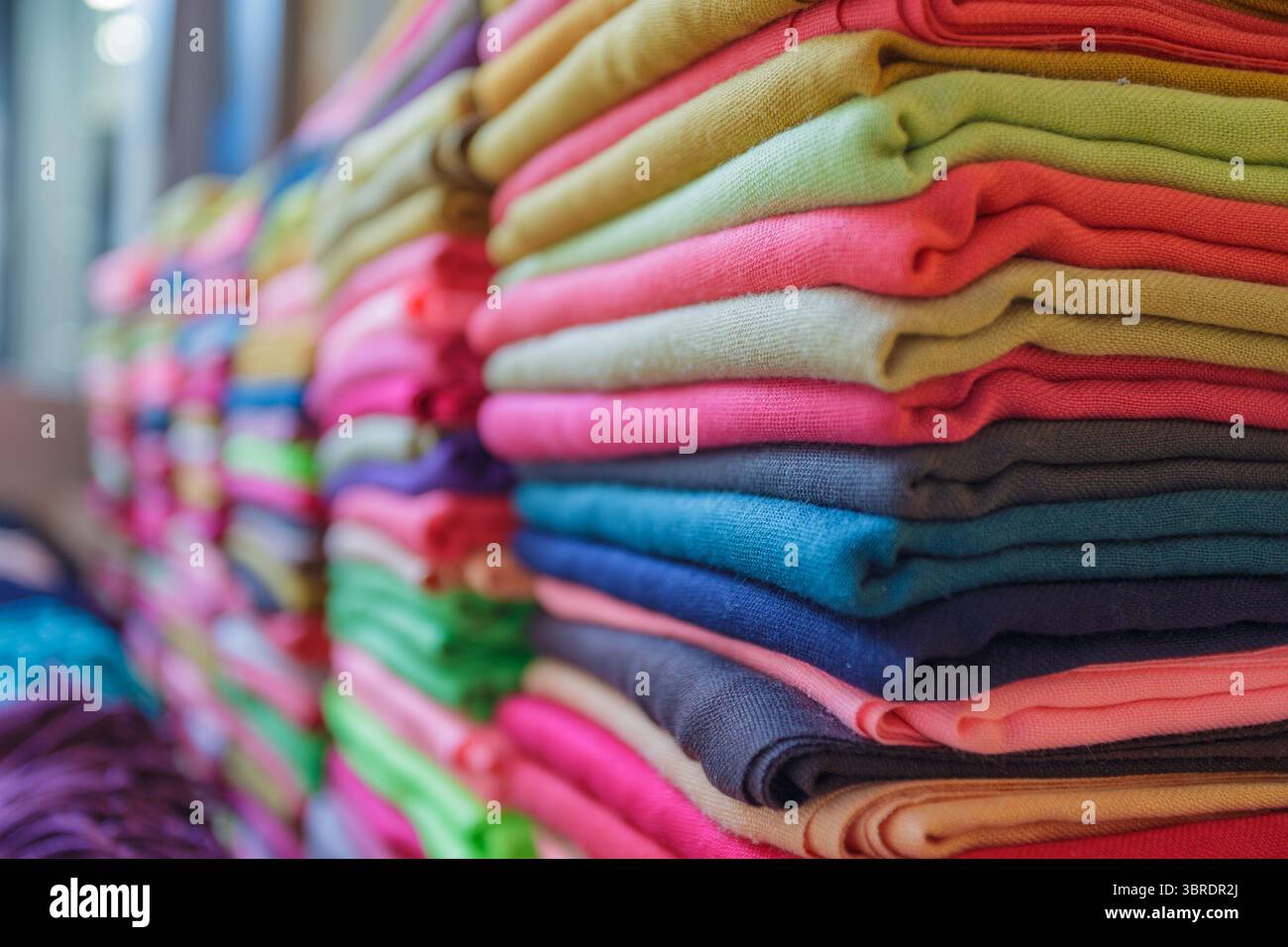 Vibrant stacks of Turkish fabrics in a textile market, showing colorful ...