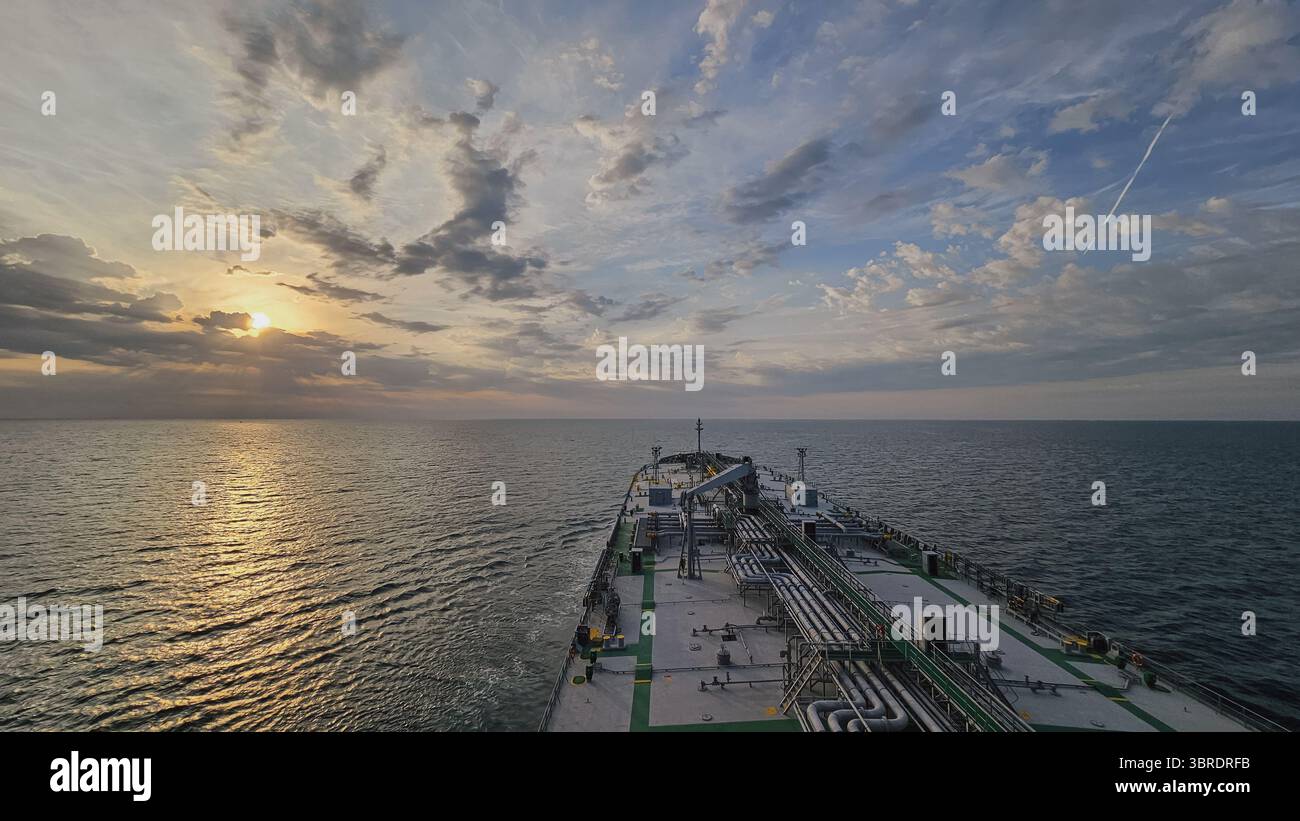 Cargo ship at sunset, view from bridge, maritime trade Stock Photo - Alamy
