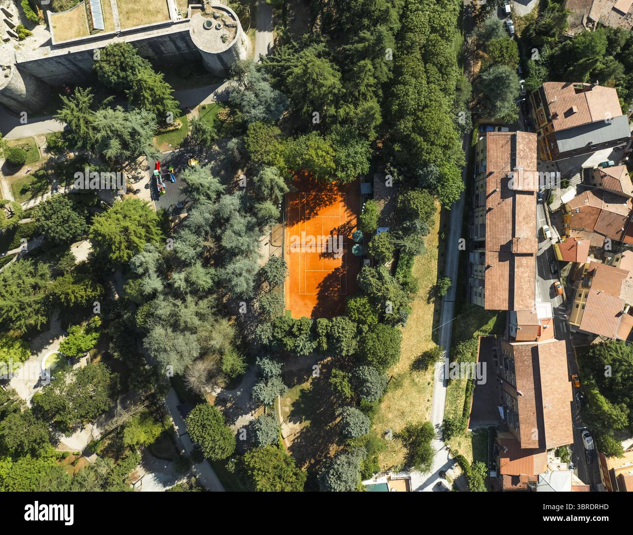 Aerial view of the red clay tennis court nestled among the verdant ...