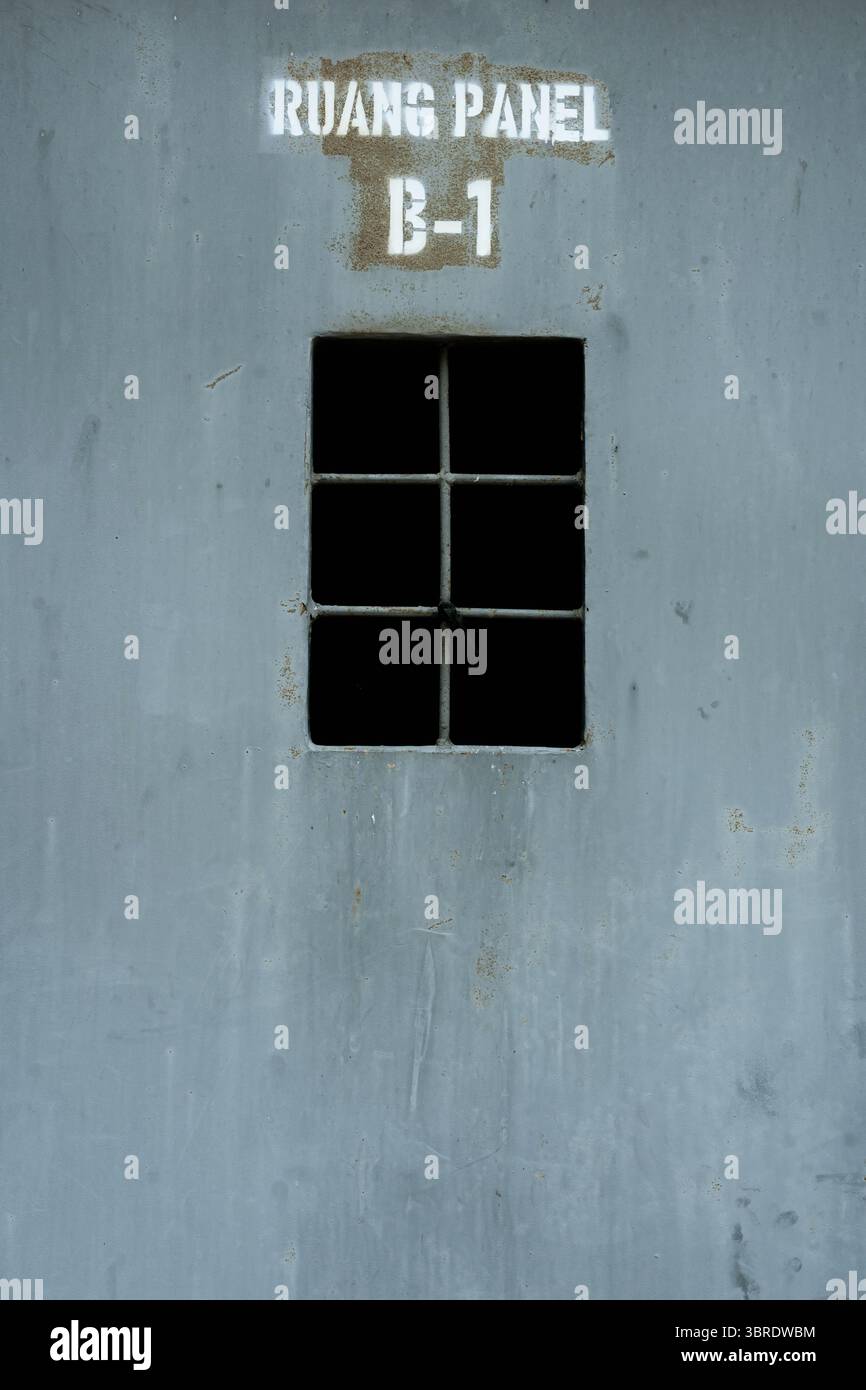 Industrial gray metal door for an electrical panel room ('Ruang Panel ...