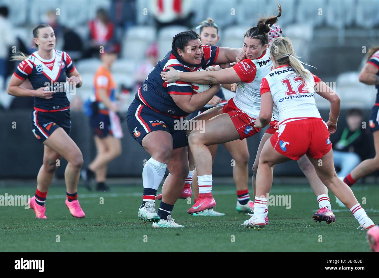 Amber Hall of the Roosters is tackled by Madison Mulhall of the Dragons ...