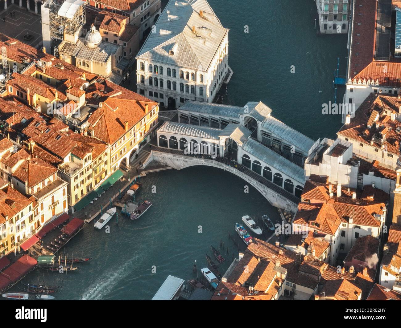 Aerial view of the Rialto Bridge spanning the Grand Canal, surrounded ...