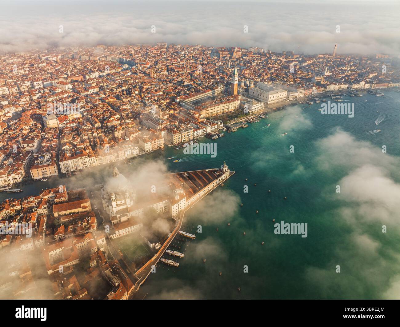 Aerial view of Venice's terracotta rooftops and turquoise waters meet ...