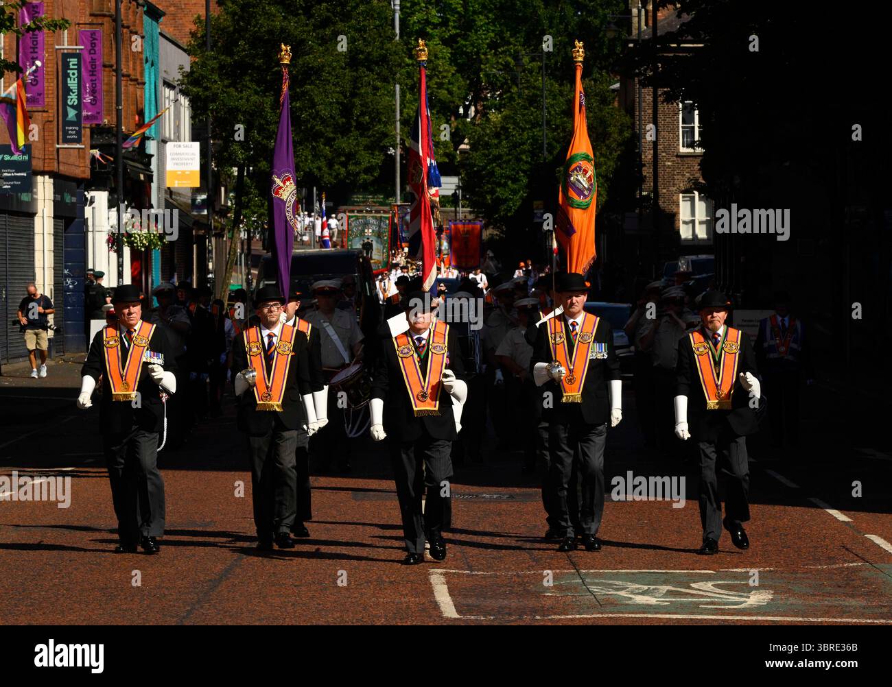 People take part in a Twelfth of July parade in Belfast, part of the ...