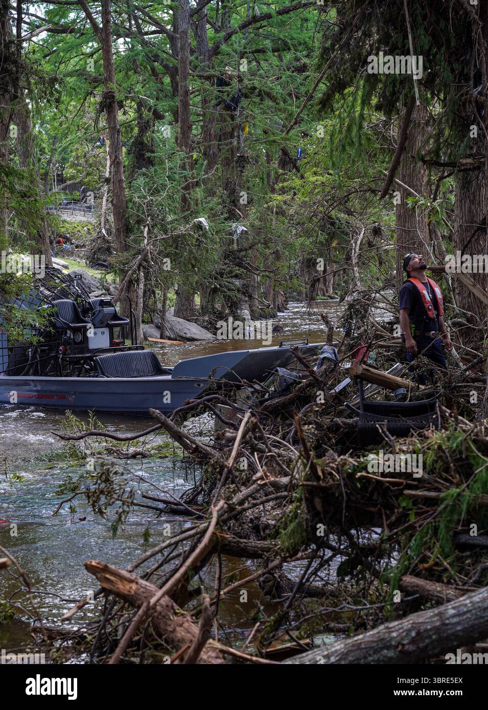 A man looks for survivors in Kerr County, TX, days after a devastating ...