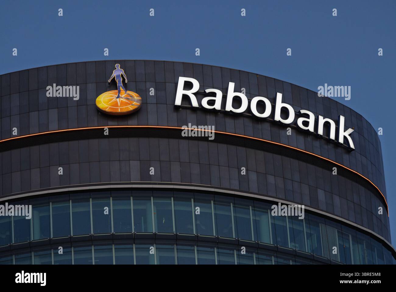 The illuminated Rabobank logo on a modern, curved corporate building ...