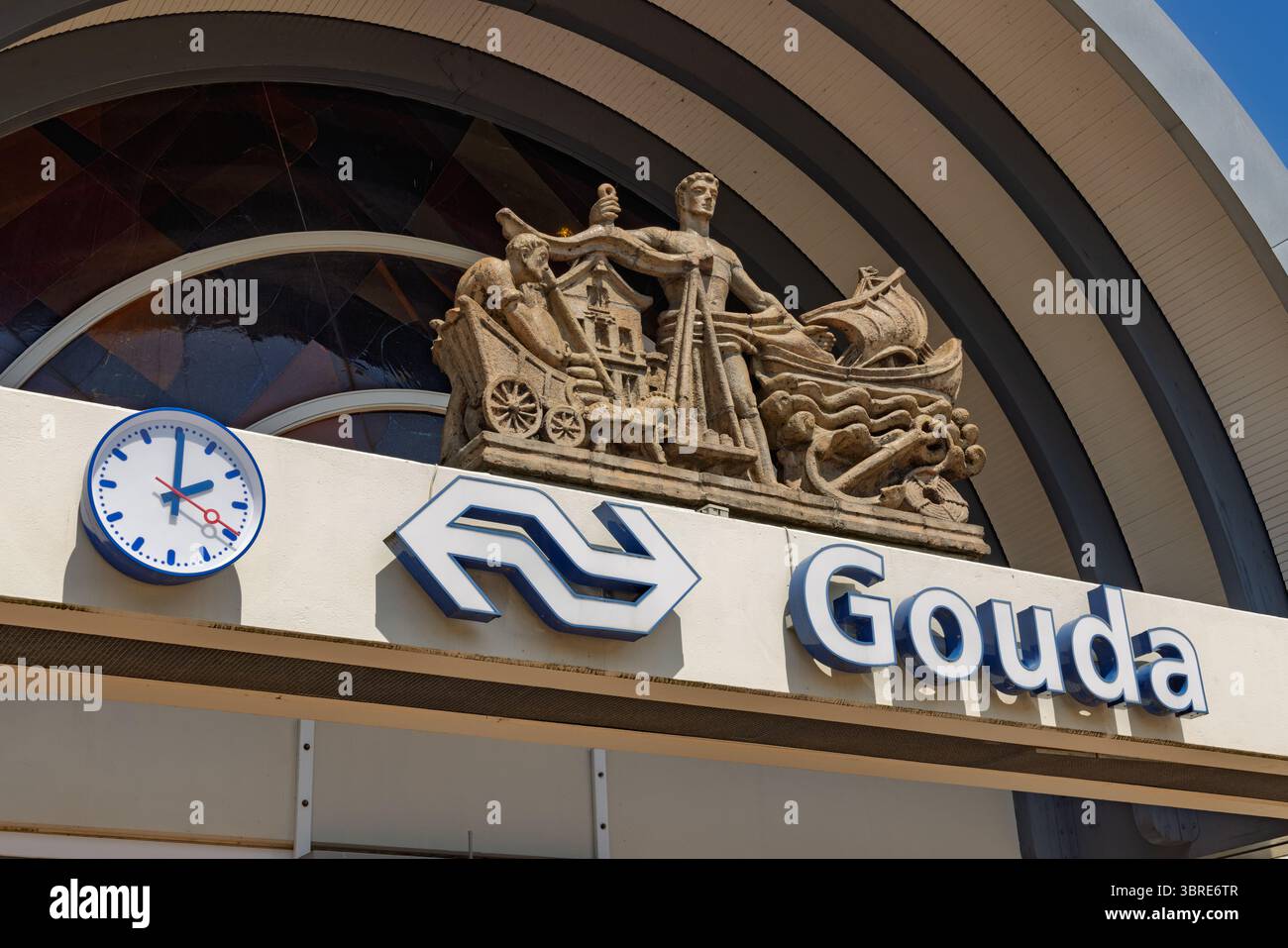 Close-up of Gouda train station entrance, featuring the NS logo, clock ...