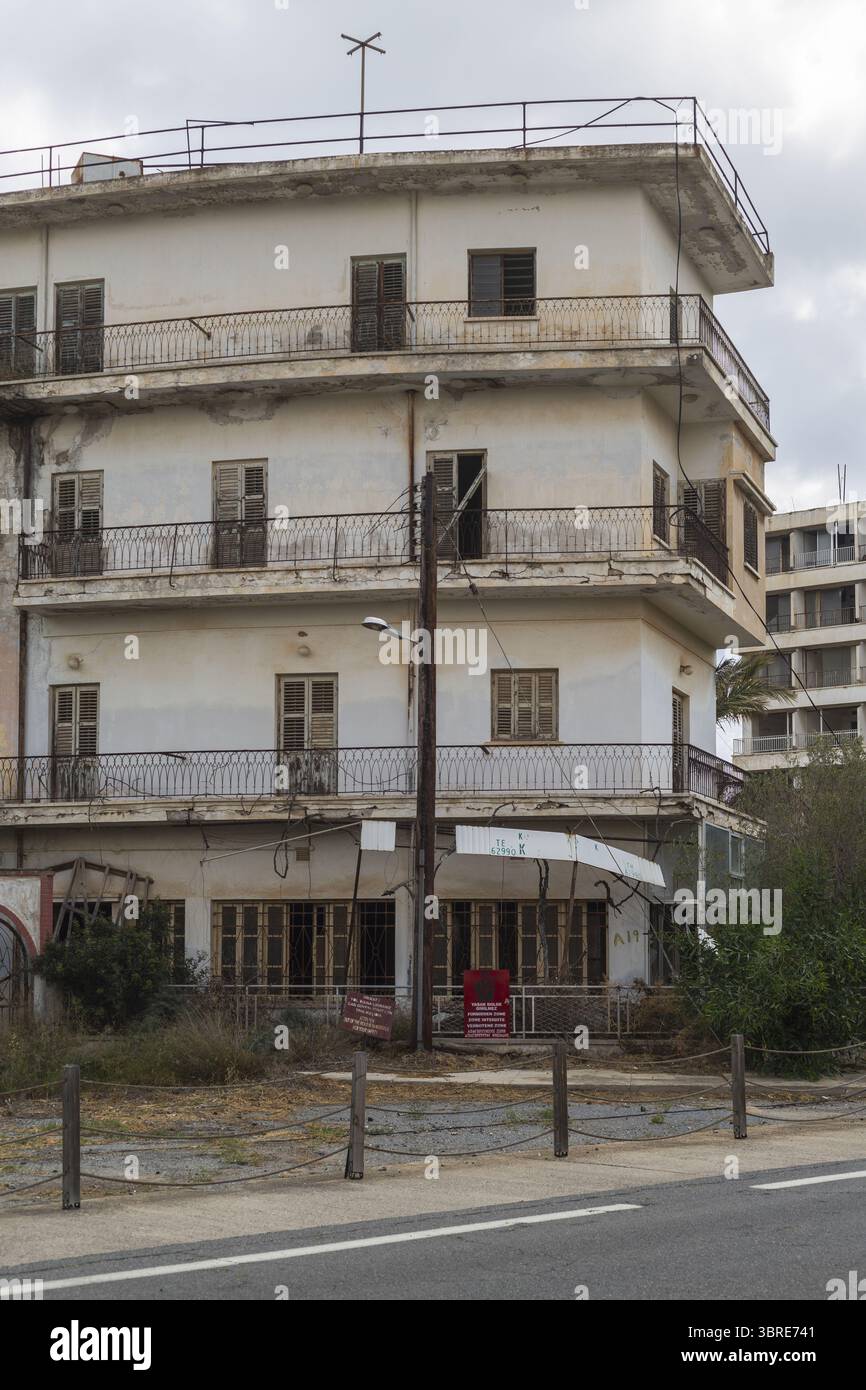 View of an aged, multi-story building with weathered balconies, faded ...