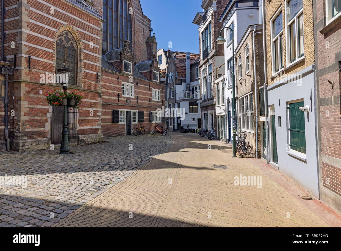 A historic Dutch alley with classic brick buildings, cobbled streets ...