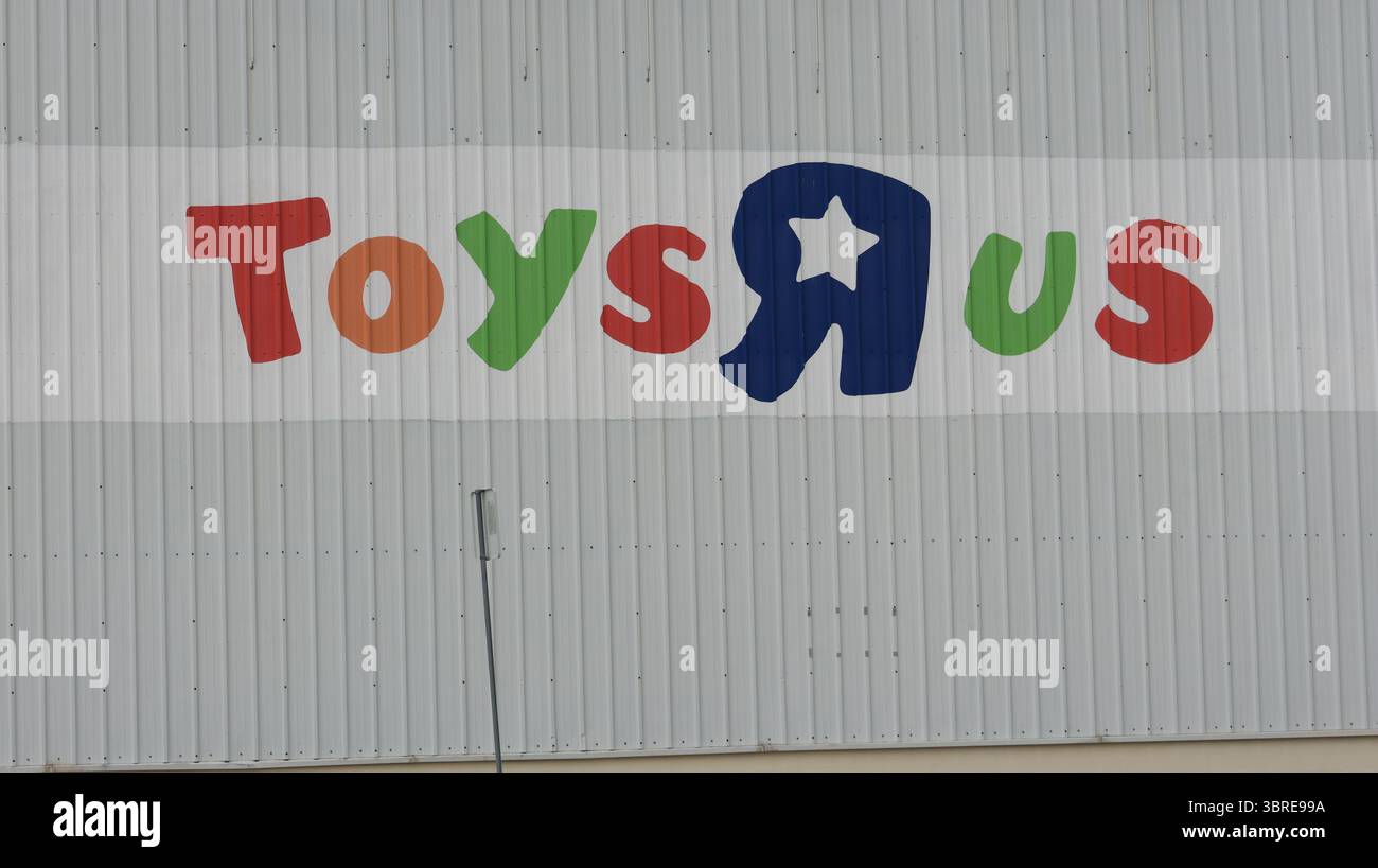 Colorful toys r us logo displayed on a corrugated metal building ...