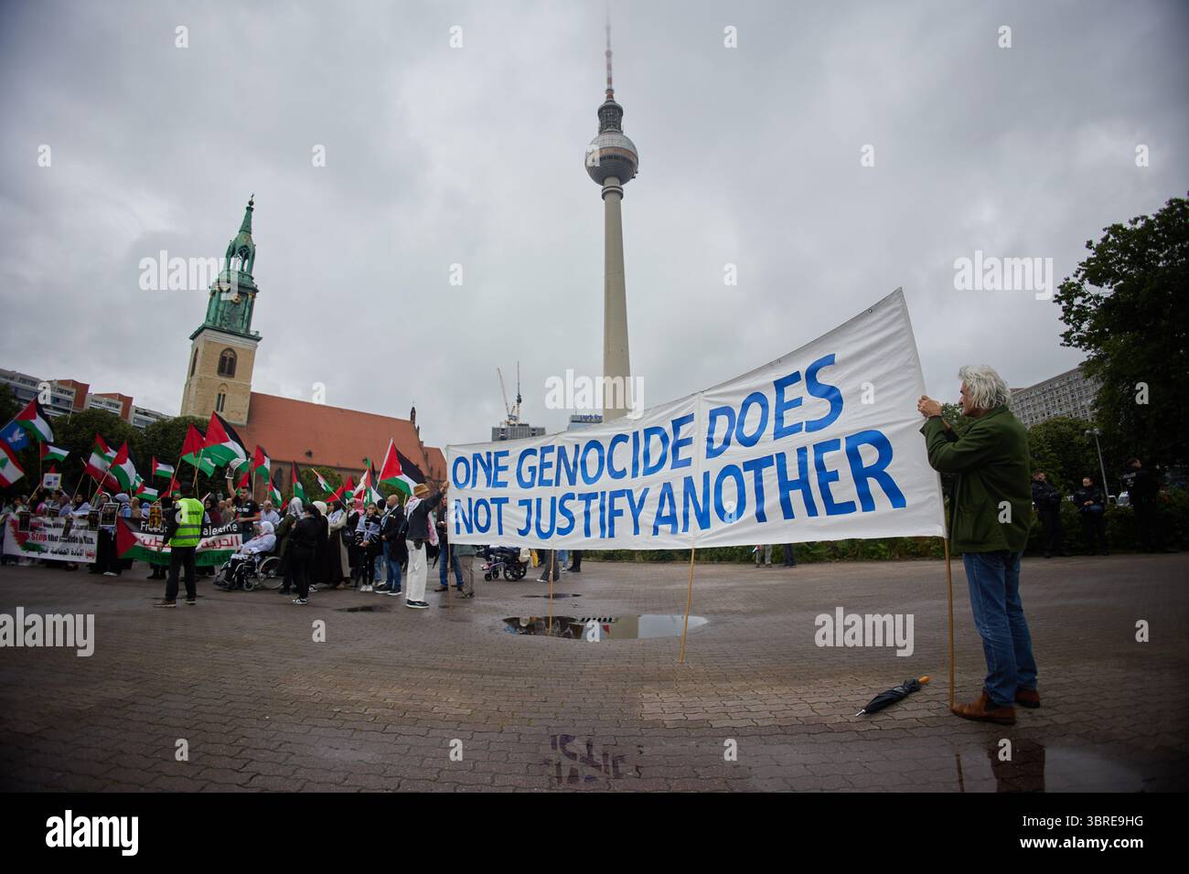 12 July 2025, Berlin: A banner reading "One genocide does not justify ...