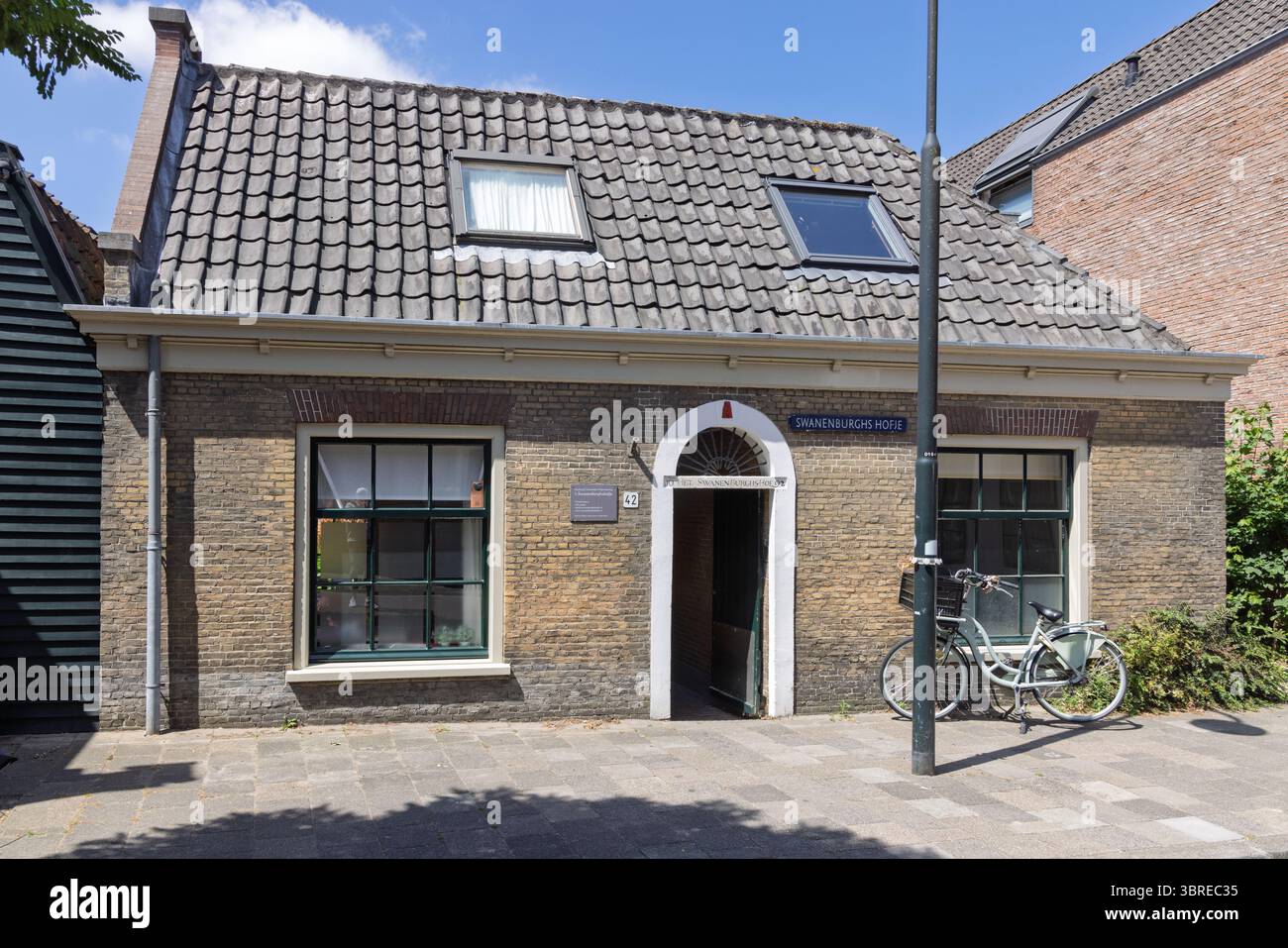 Historic small Dutch house "Swanenburghshofje" with a tiled roof and ...