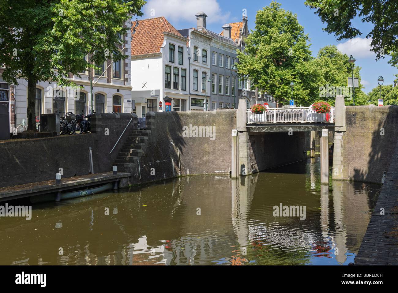 Picturesque canal and bridge in a Dutch city Gouda, bordered by ...