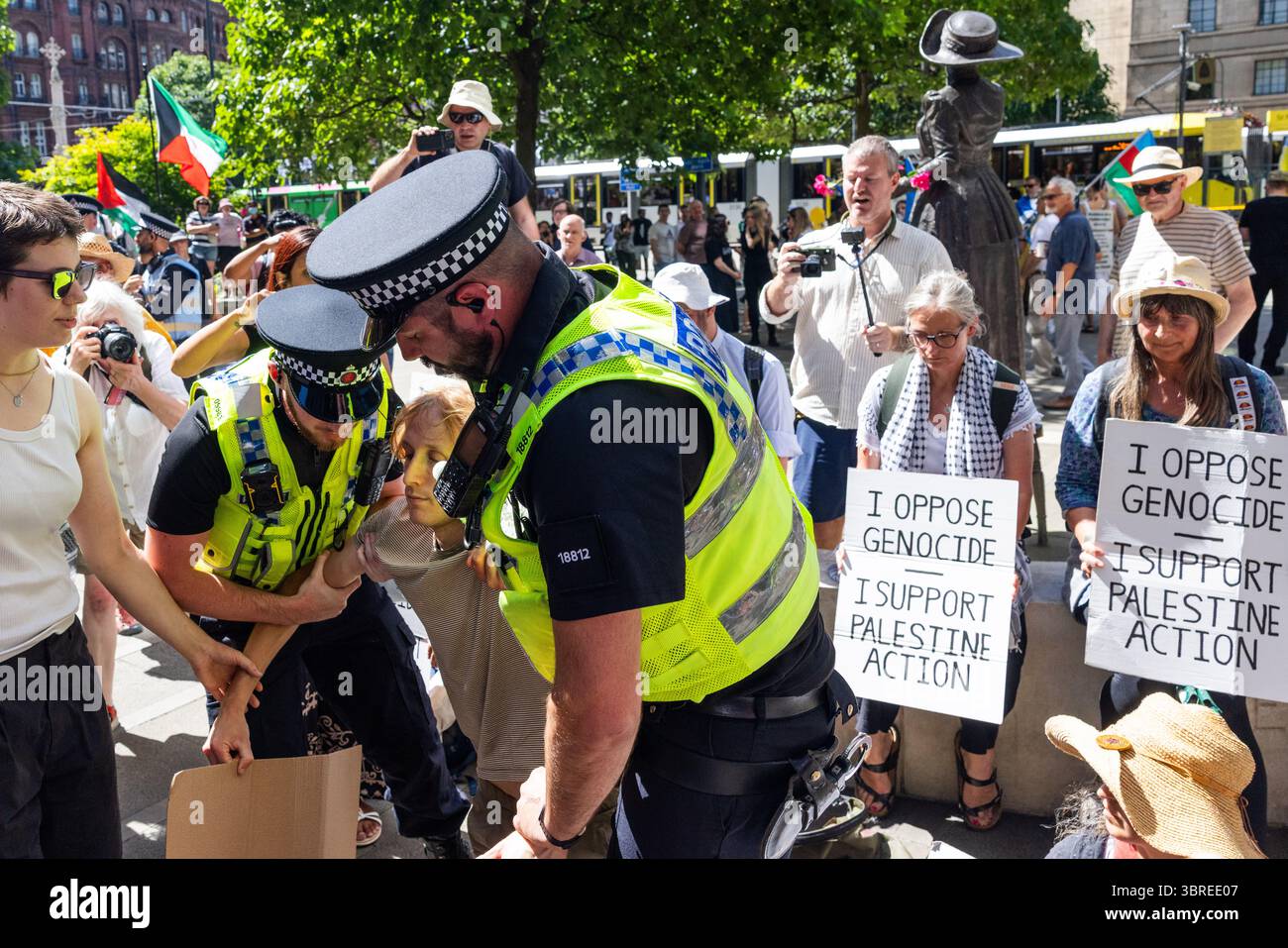Manchester, UK. 12 JUL, 2025. People hold signs prior to arrests at a ...
