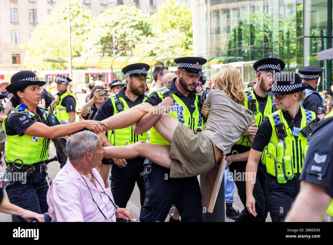 Manchester, UK. 12 JUL, 2025. People hold signs prior to arrests at a ...