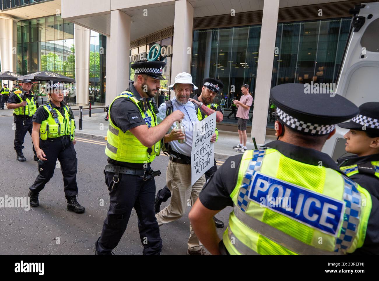 A man with a dog collar holds a banner supporting Palestine action and ...