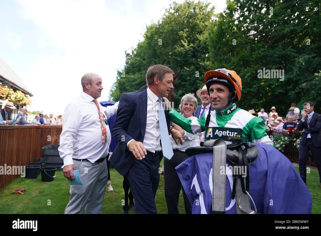 Jockey Neil Callan and trainer Richard Hughes (second left) celebrate ...