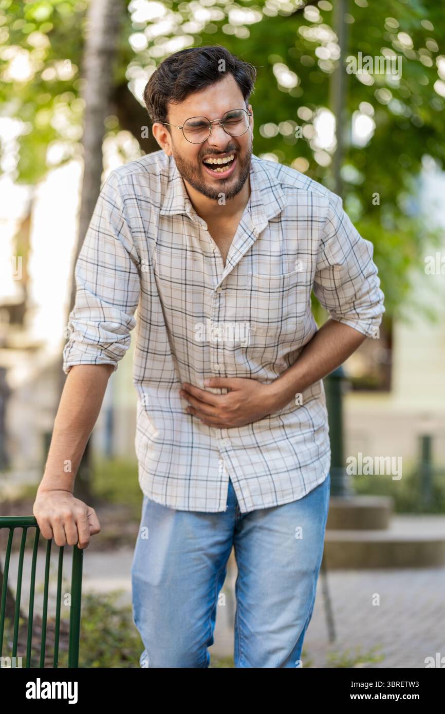 Arabian young man traveler feeling sudden strong abdominal stomach ache ...