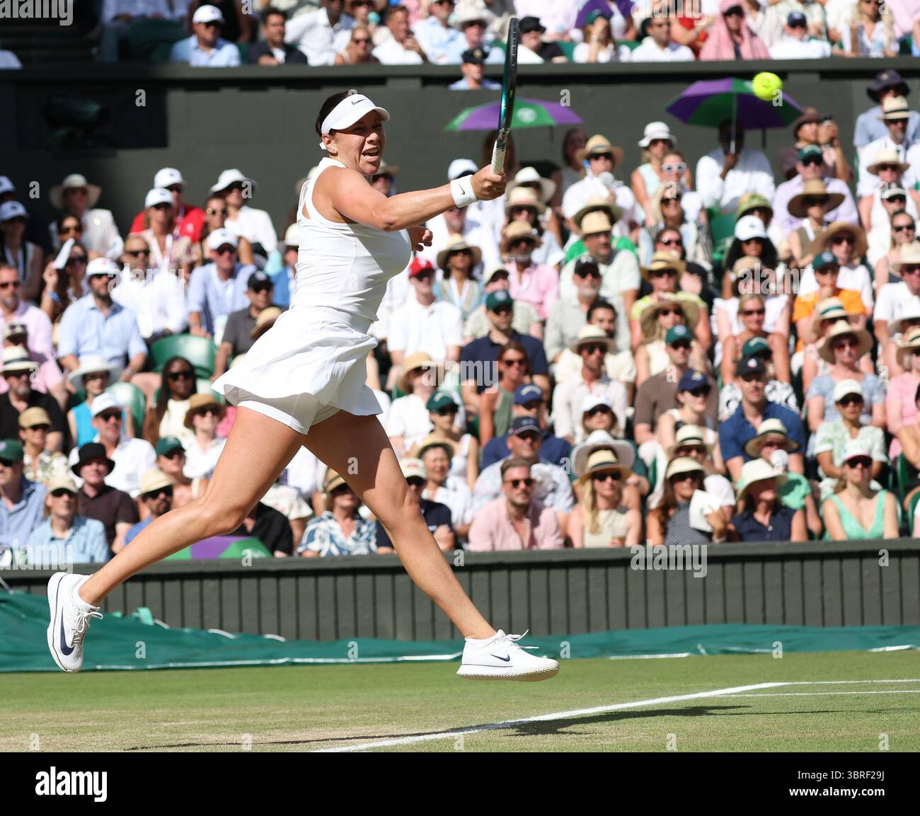London, UK. 12th July, 2025. American Amanda Anisimova plays a forehand in the Women's Wimbledon ...