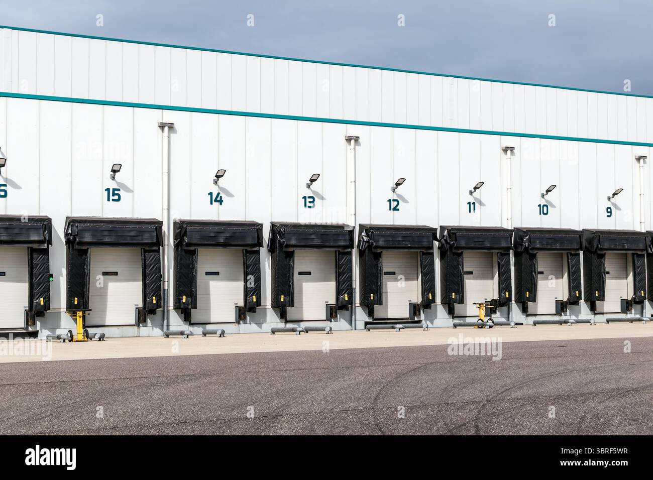 Modern industrial logistics warehouse row of closed loading docks with ...