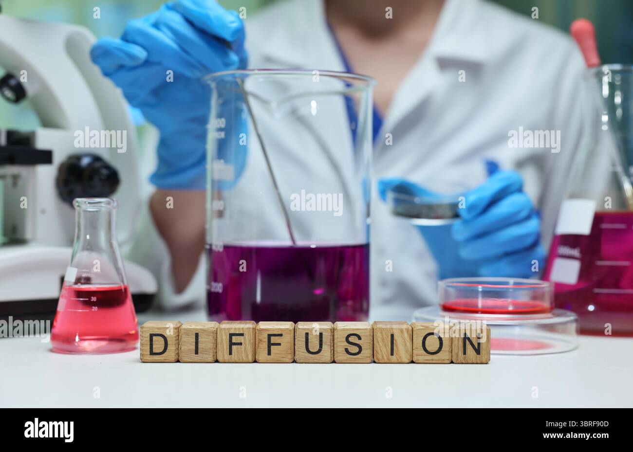 A scientist demonstrates the fascinating process of diffusion in a lab ...