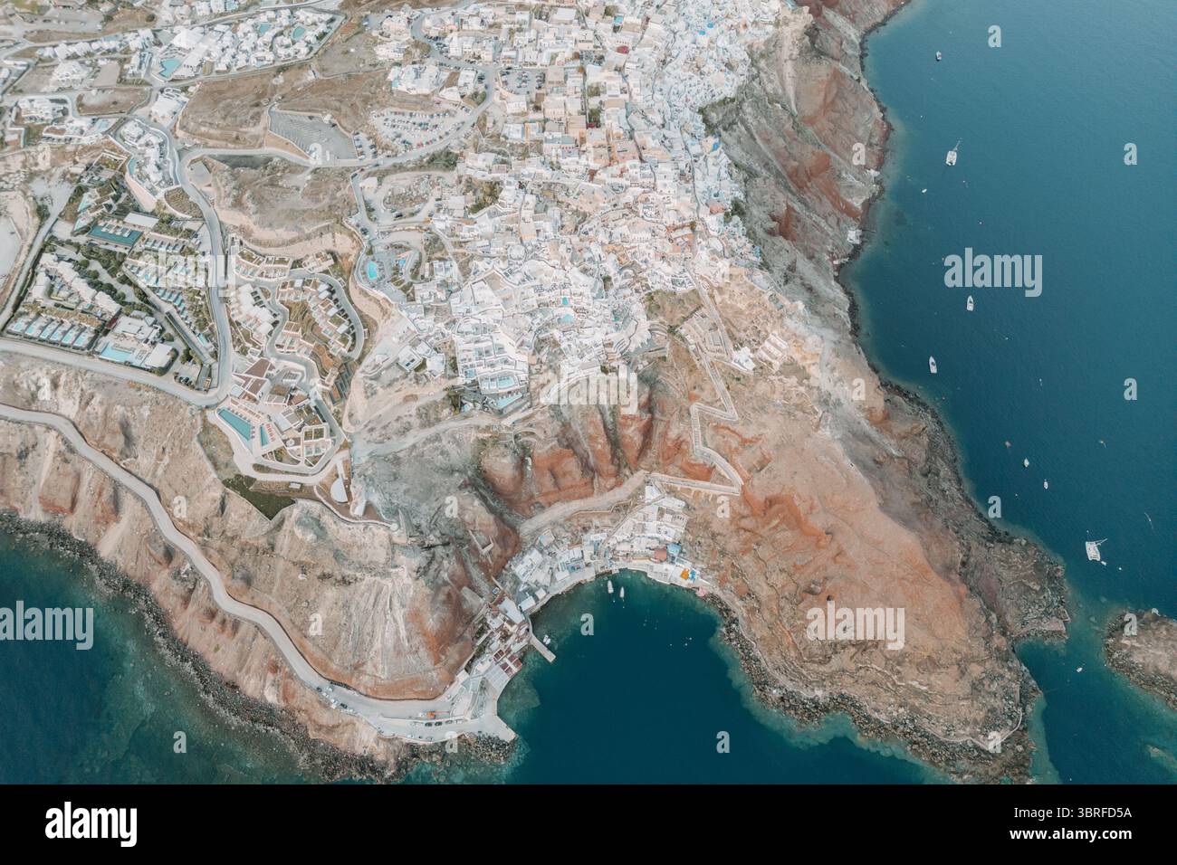 Drone photo of Oia, Santorini showing white houses built on steep ...