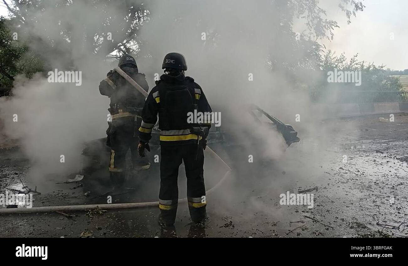 Ukrainian firefighters work to extinguish a fire following mass Russian ...