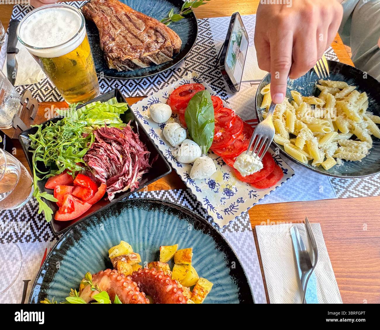 A vibrant dining table filled with Italian delicacies including pasta ...
