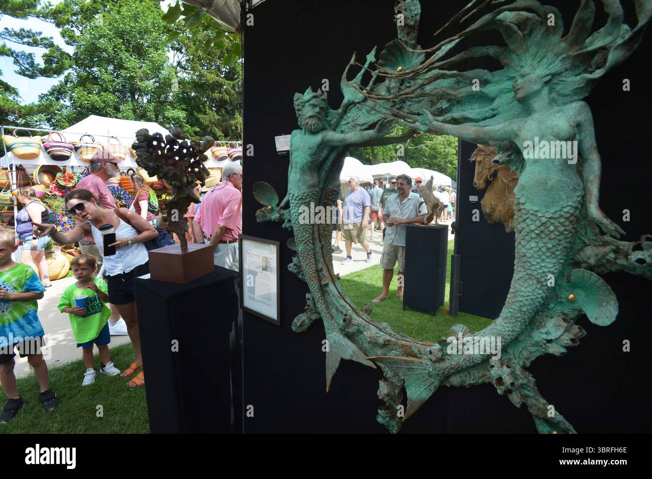 Artist Ruben Medina, of Cape Coral, Fla., is reflected in his artwork ...