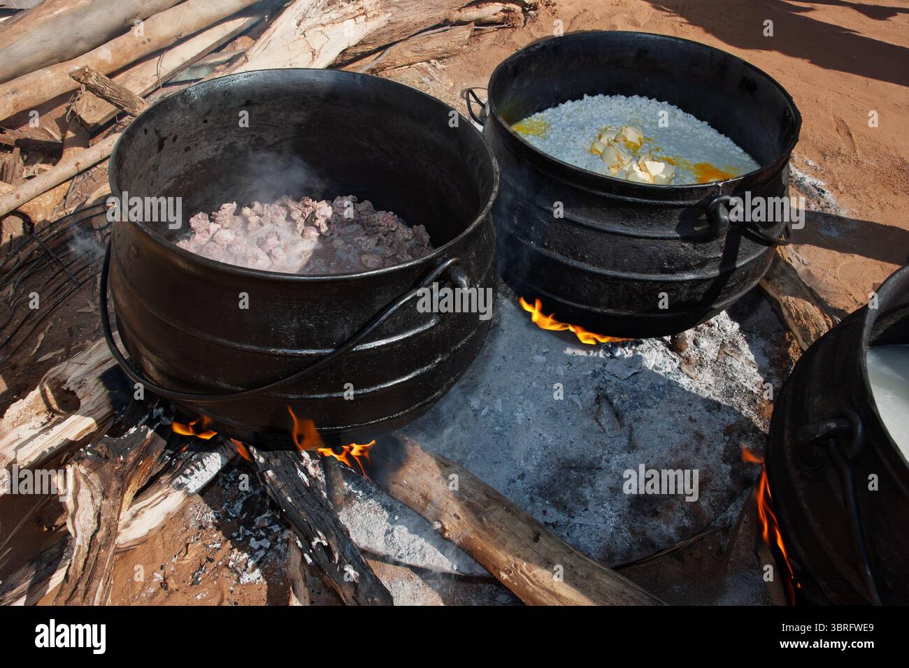 african cooking three legged pots outdoors on the fire, boiling beef ...