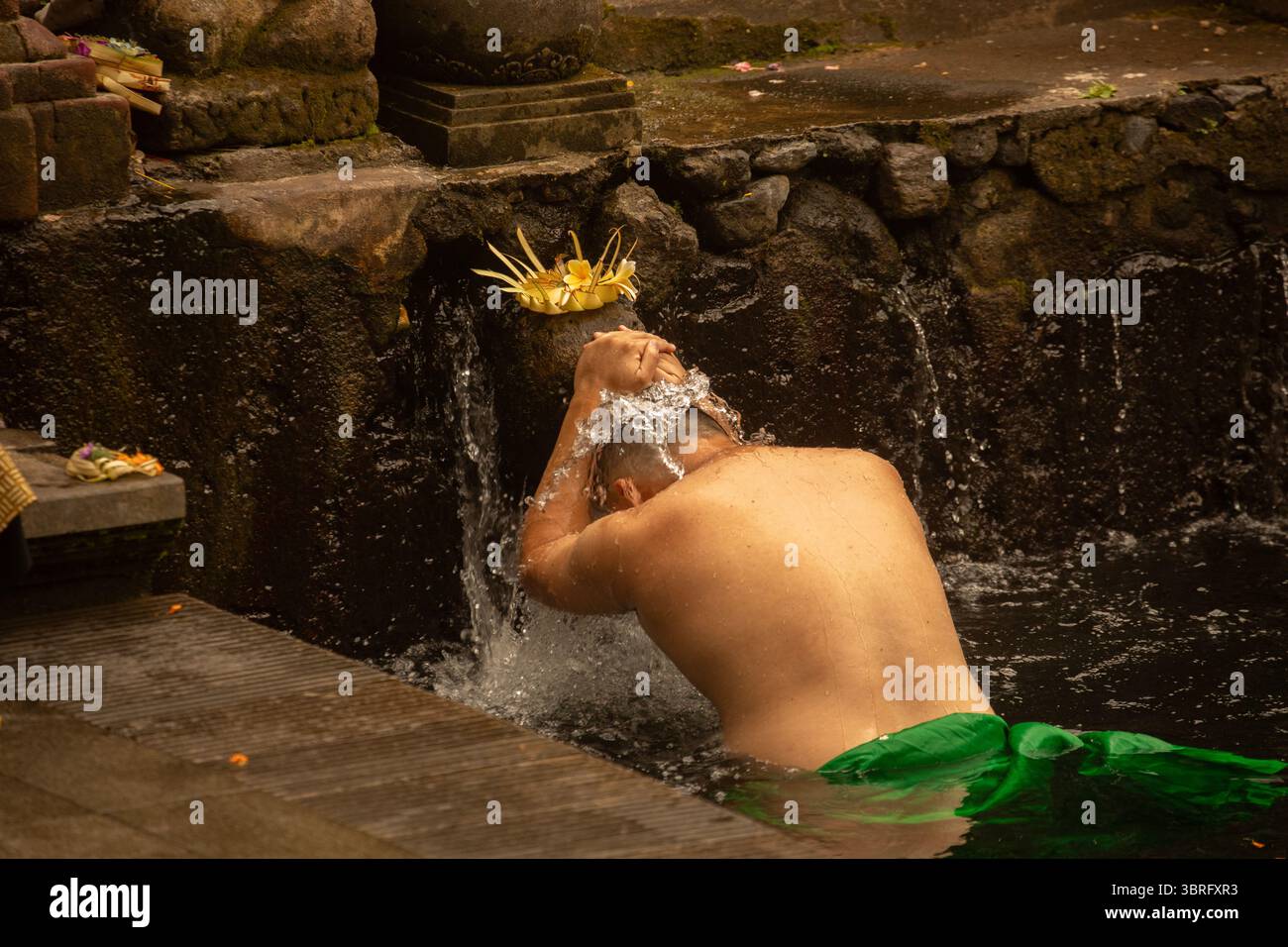Pura Tirta Empul Temple, Bali, Indonesia, where visitors perform a ...