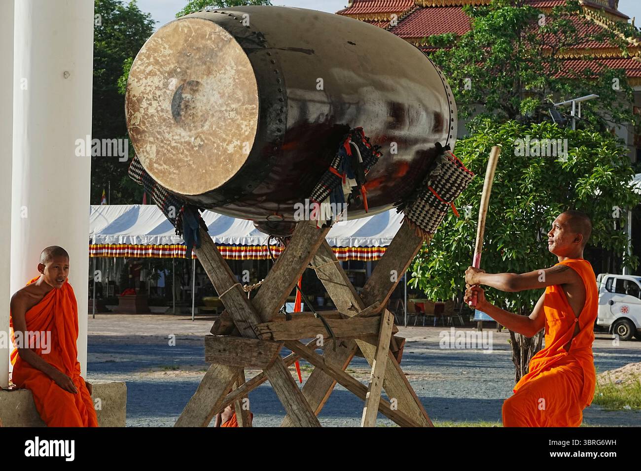 A Buddhist monk, right, beats a giant drum at a pagoda after the three ...