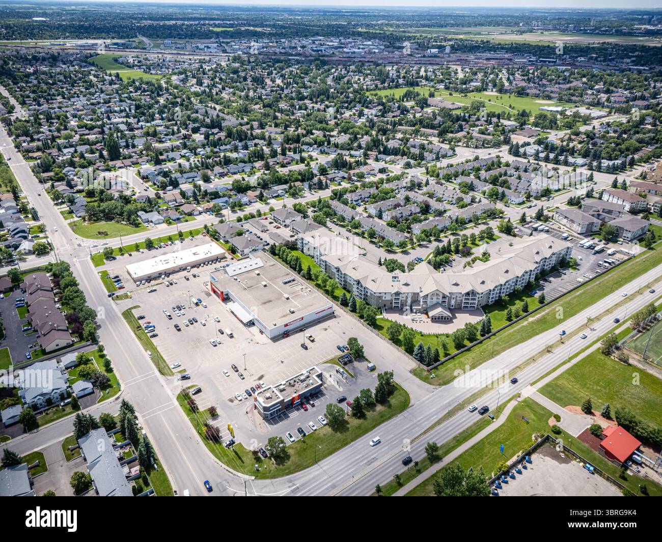 City street with a large shopping center in the background. The ...