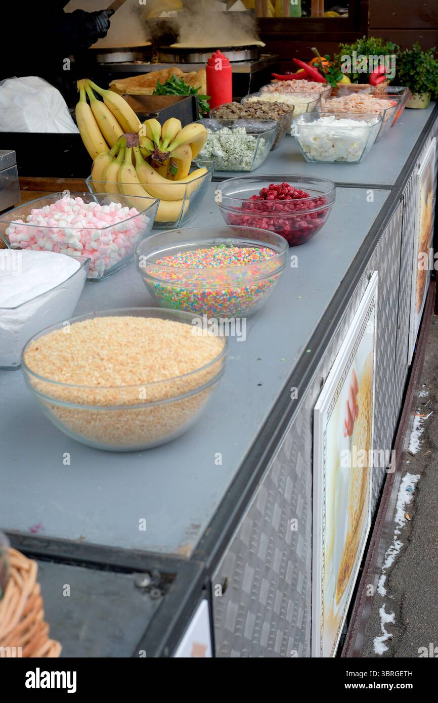 A vibrant assortment of dessert toppings is displayed at the market ...