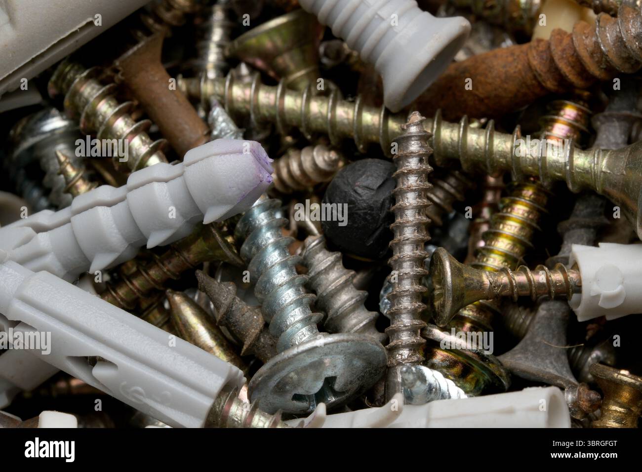 A colorful mix of screws and fasteners spreads across the surface Stock ...