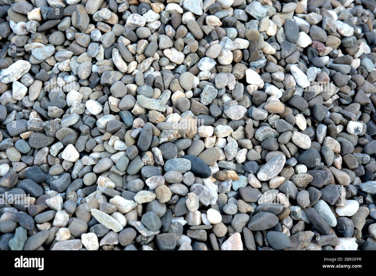 Colorful and smooth round stones form an artistic arrangement in nature ...