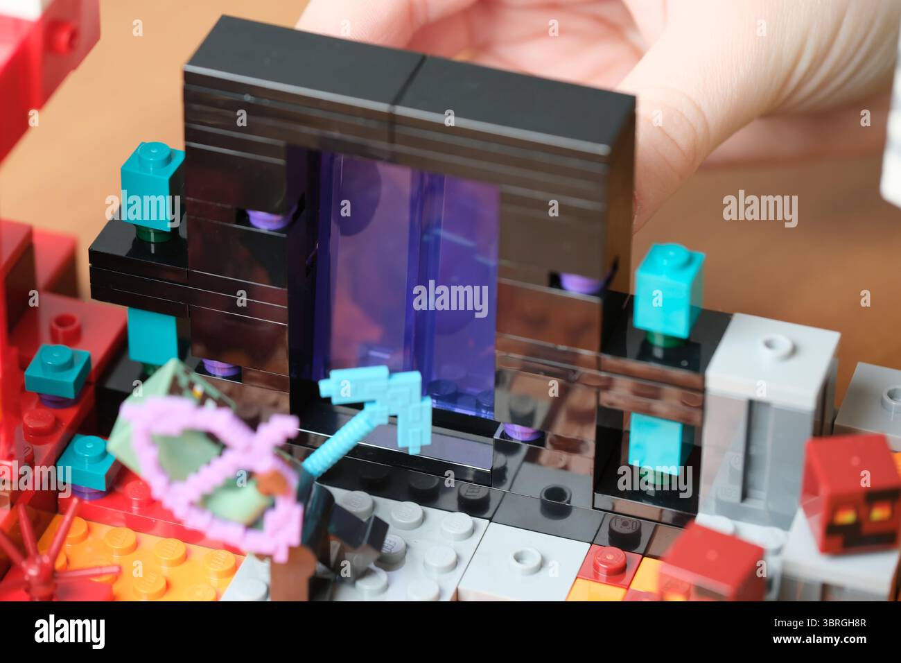 A hand carefully assembles a vibrant portal using colorful blocks Stock ...