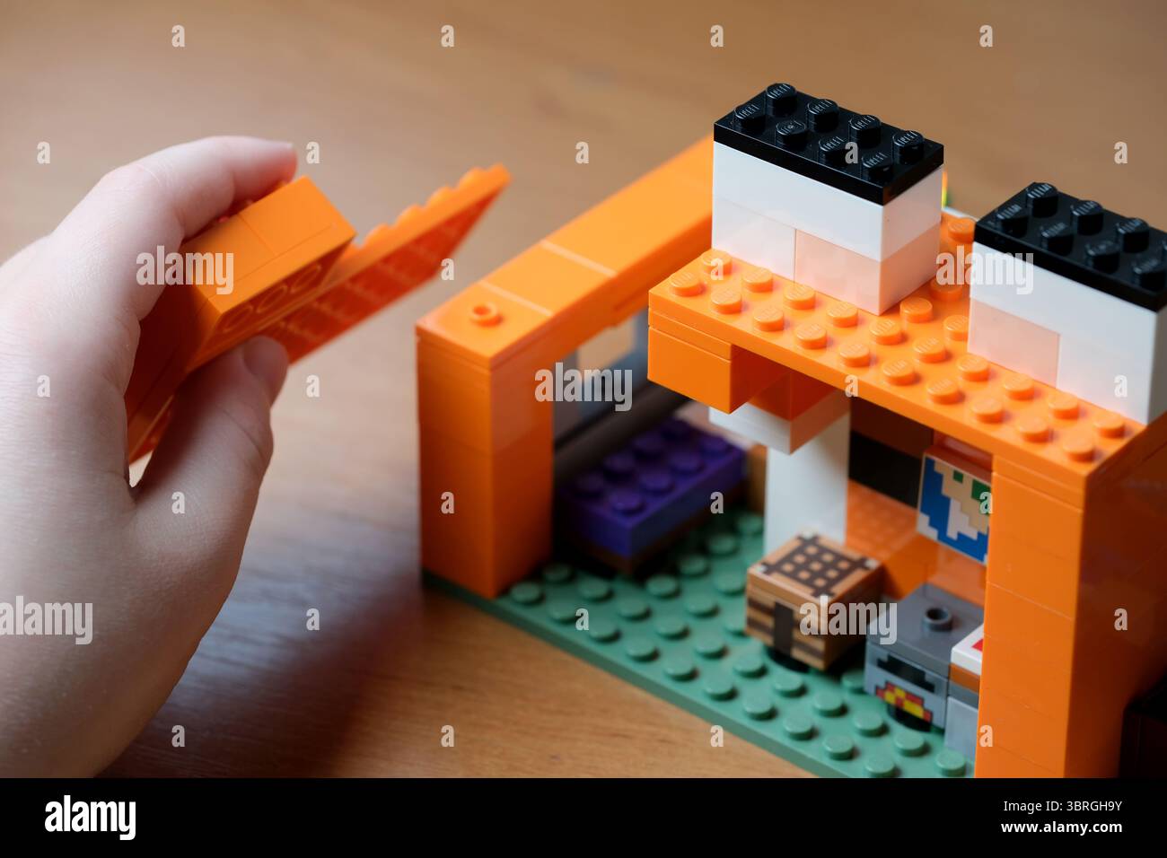 Engaging in a fun activity of constructing a vibrant Lego model Stock ...