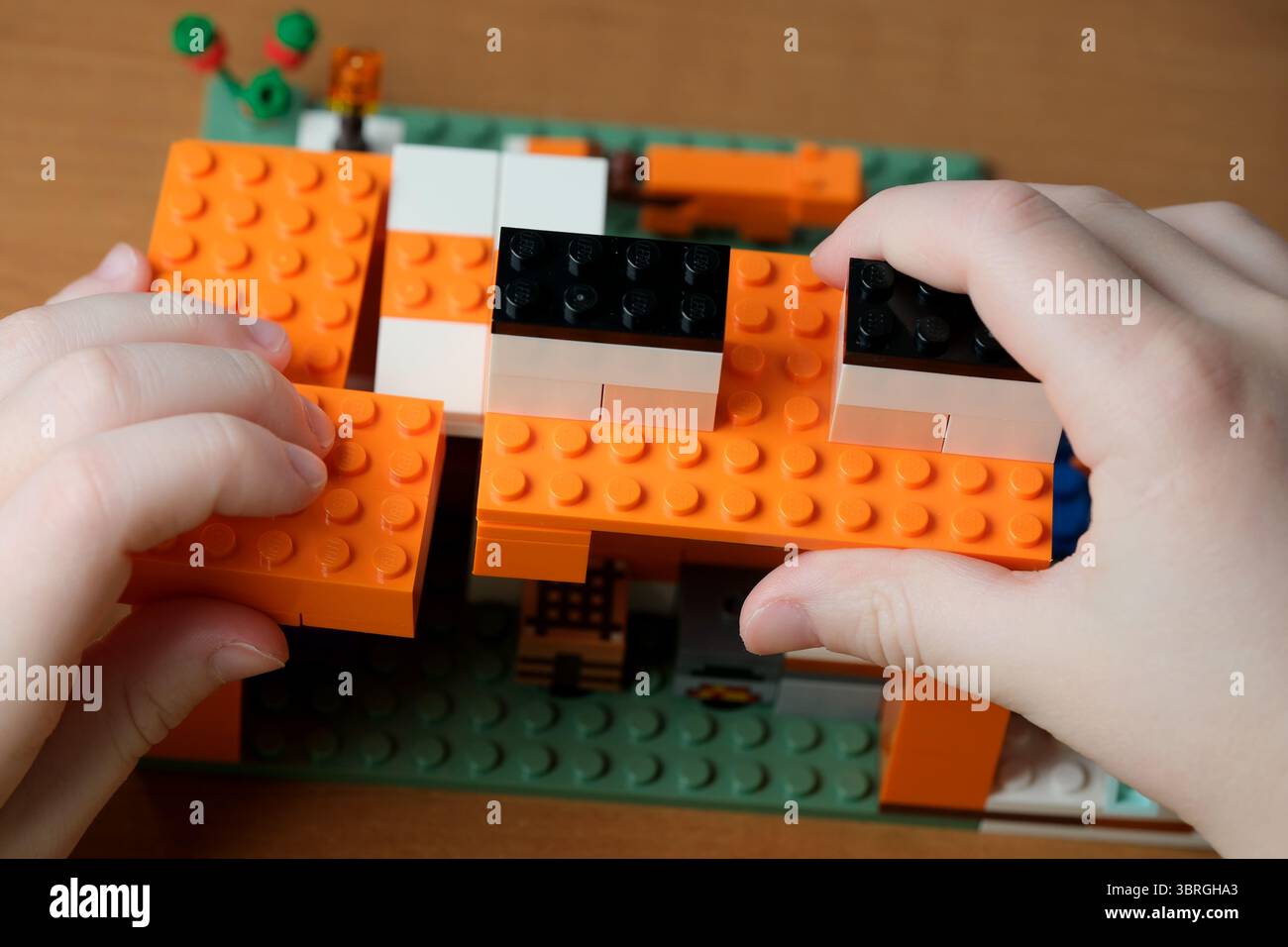 Two hands assemble vibrant blocks in a cozy crafting environment Stock ...