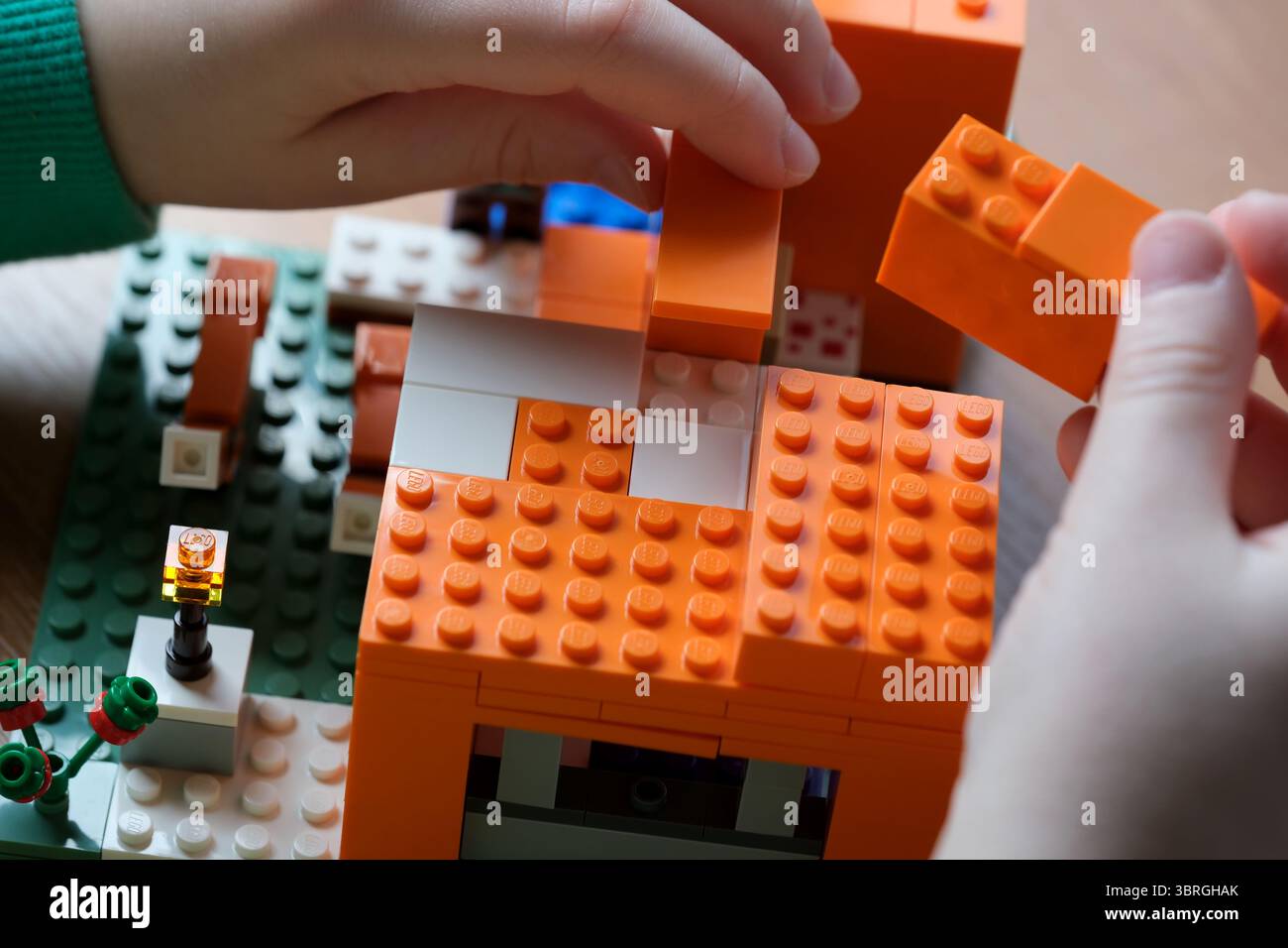 Hands carefully assemble vibrant blocks into a playful structure Stock ...