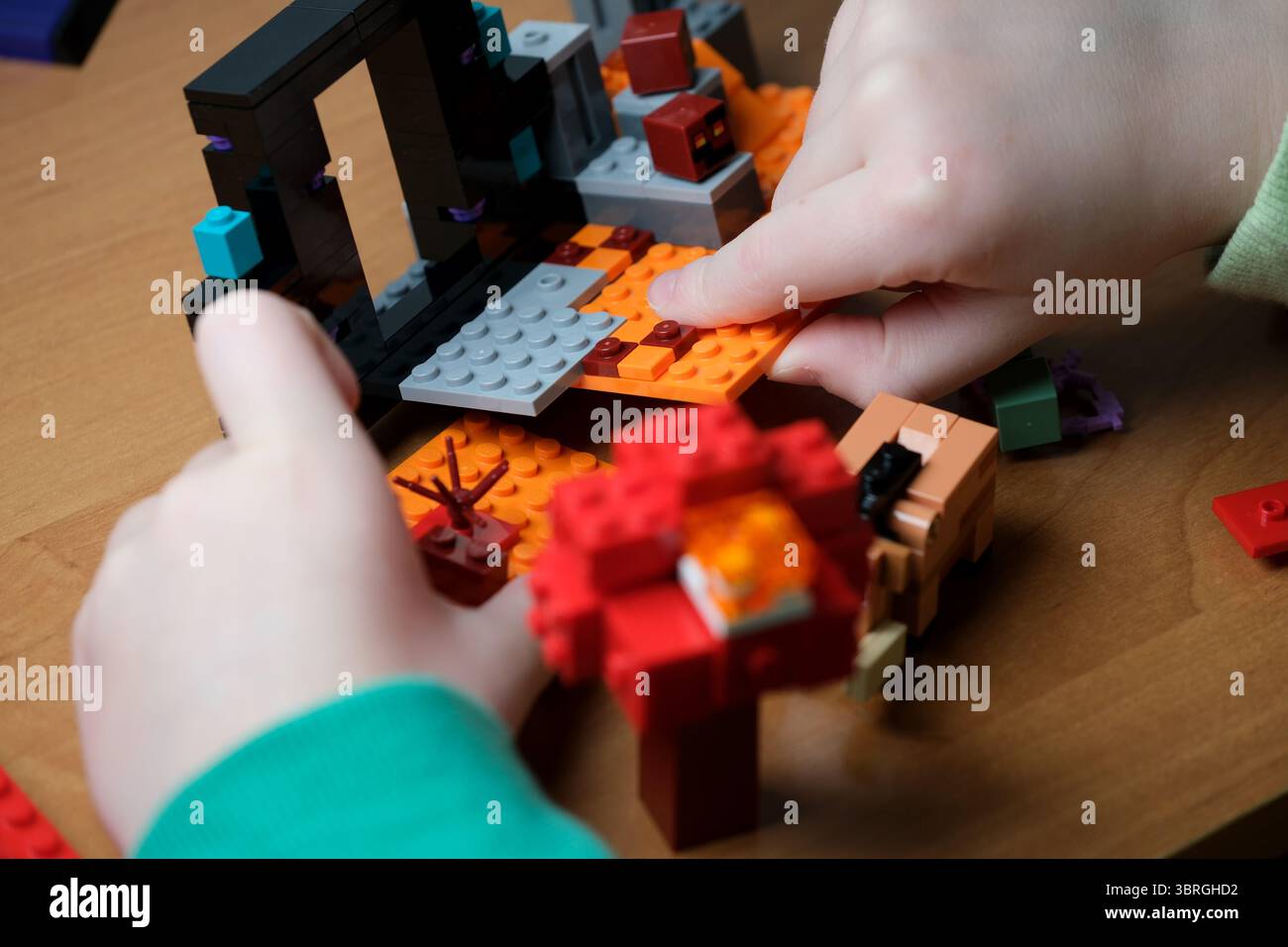 Hands assemble colorful blocks into a creative structure while playing ...