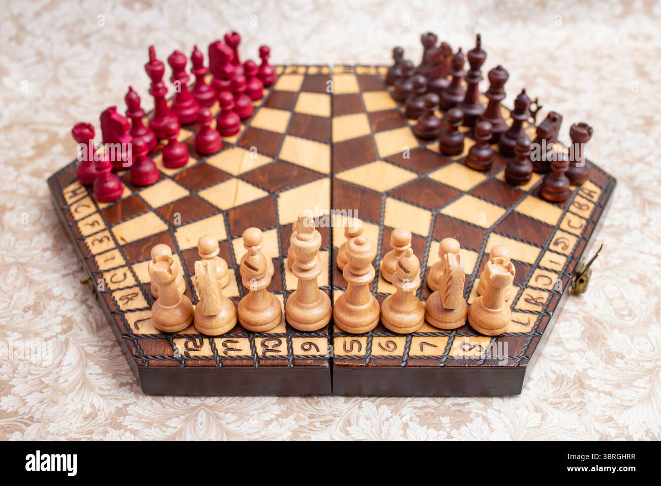 Three player chess board with black, white and red color pieces, on ...